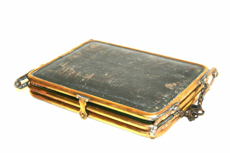 A three-fold brass-mounted leather travelling mirror, early 20th ...