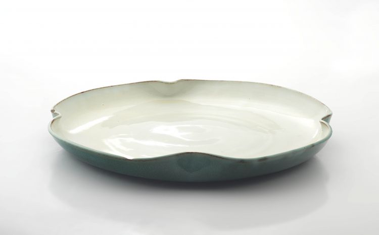 A Linn Ware green and cream-glazed dish | Strauss & Co
