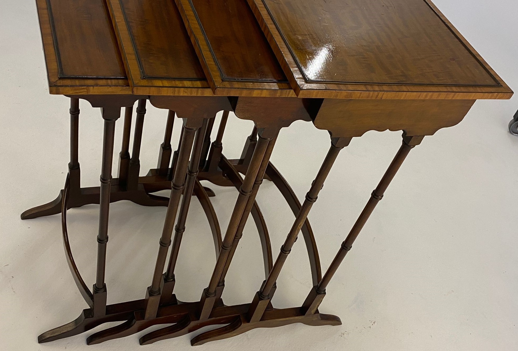 A nest of four George III style mahogany quartetto tables | Strauss & Co